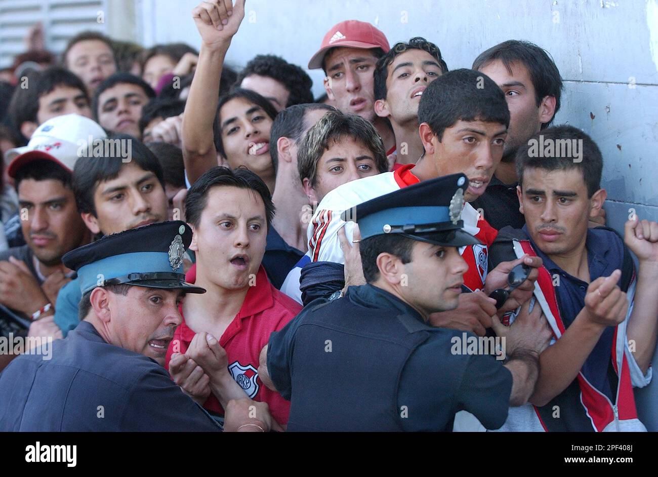 Police officers push soccer fans waiting for hours for the ticket sales ...