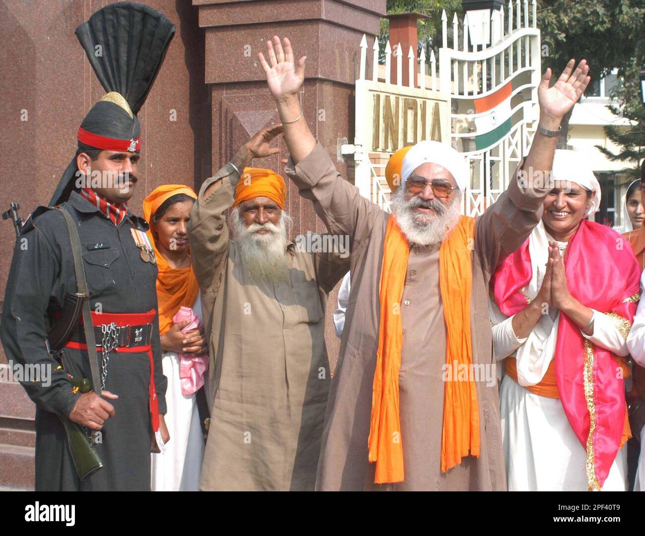 Indian Sikhs wave after crossing into Pakistan through Wagha border ...