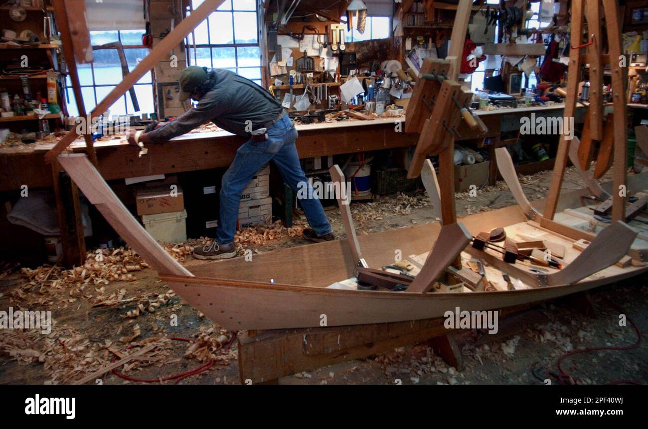 Peter Gibb planes down a plank while building the side of a Salisbury ...