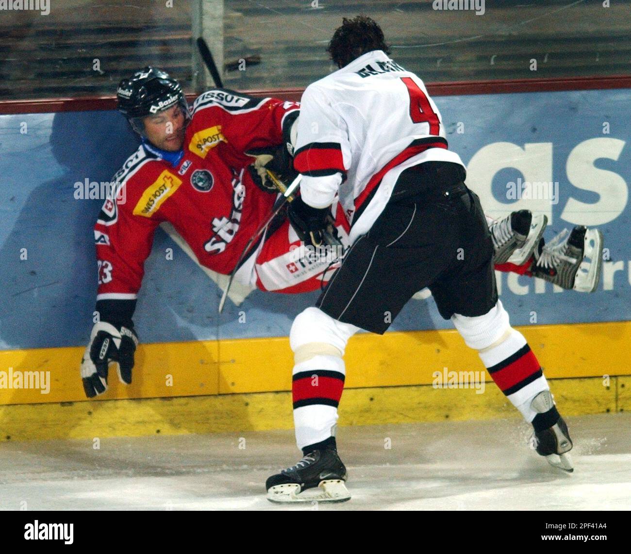 Canada's Chris Belanger, right, fights for the puck with Swiss Thierry ...