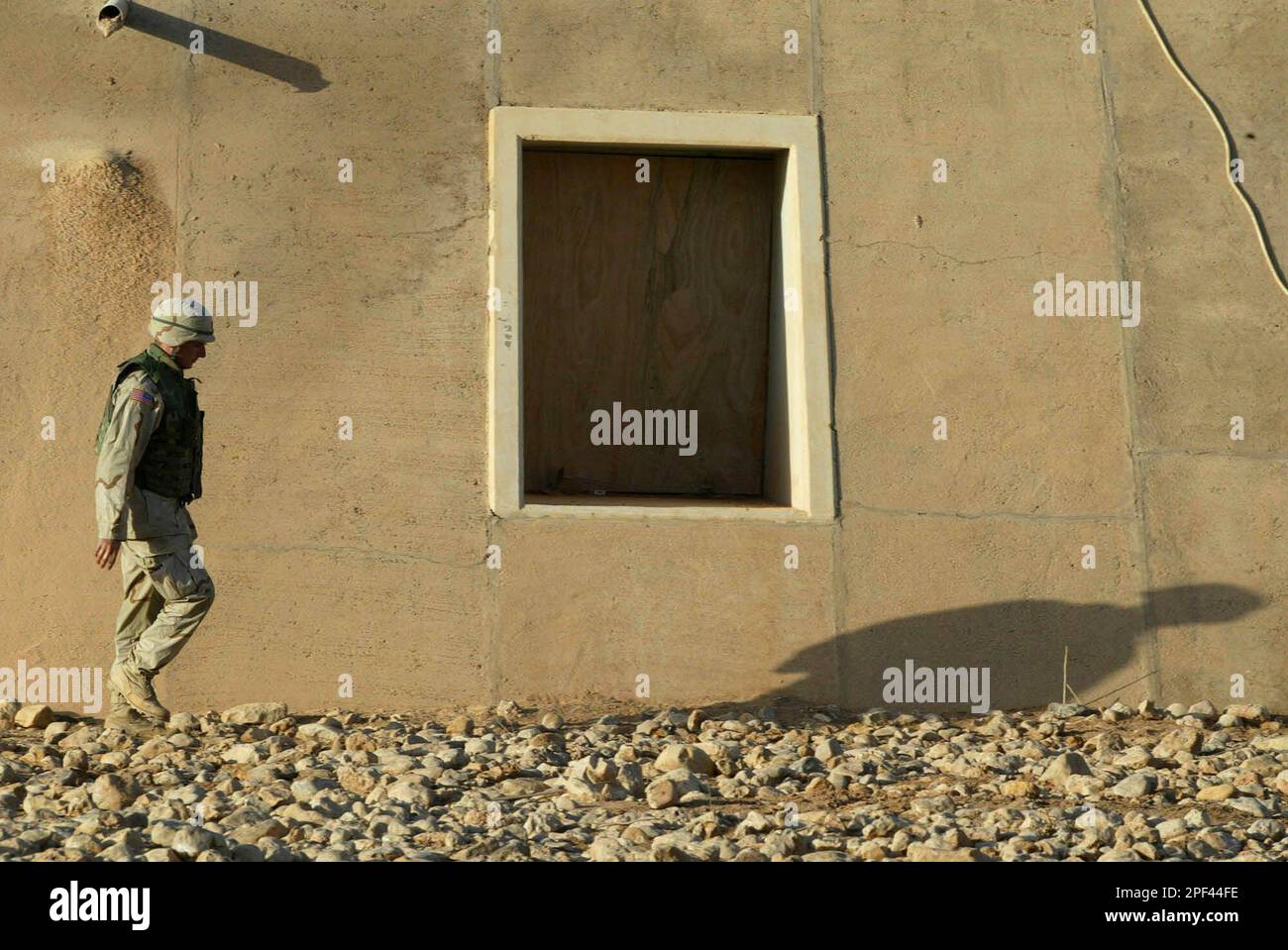 A soldier walks past a bunker now being used as a sleeping quarters for ...