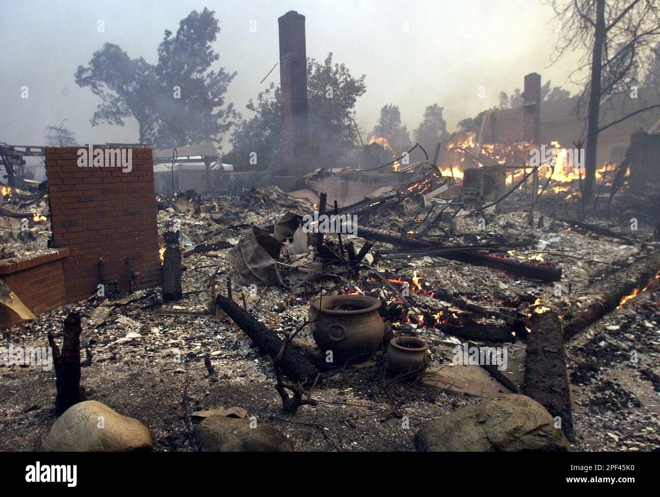 Chimneys remain standing after a wildfire swept through a neighborhood ...