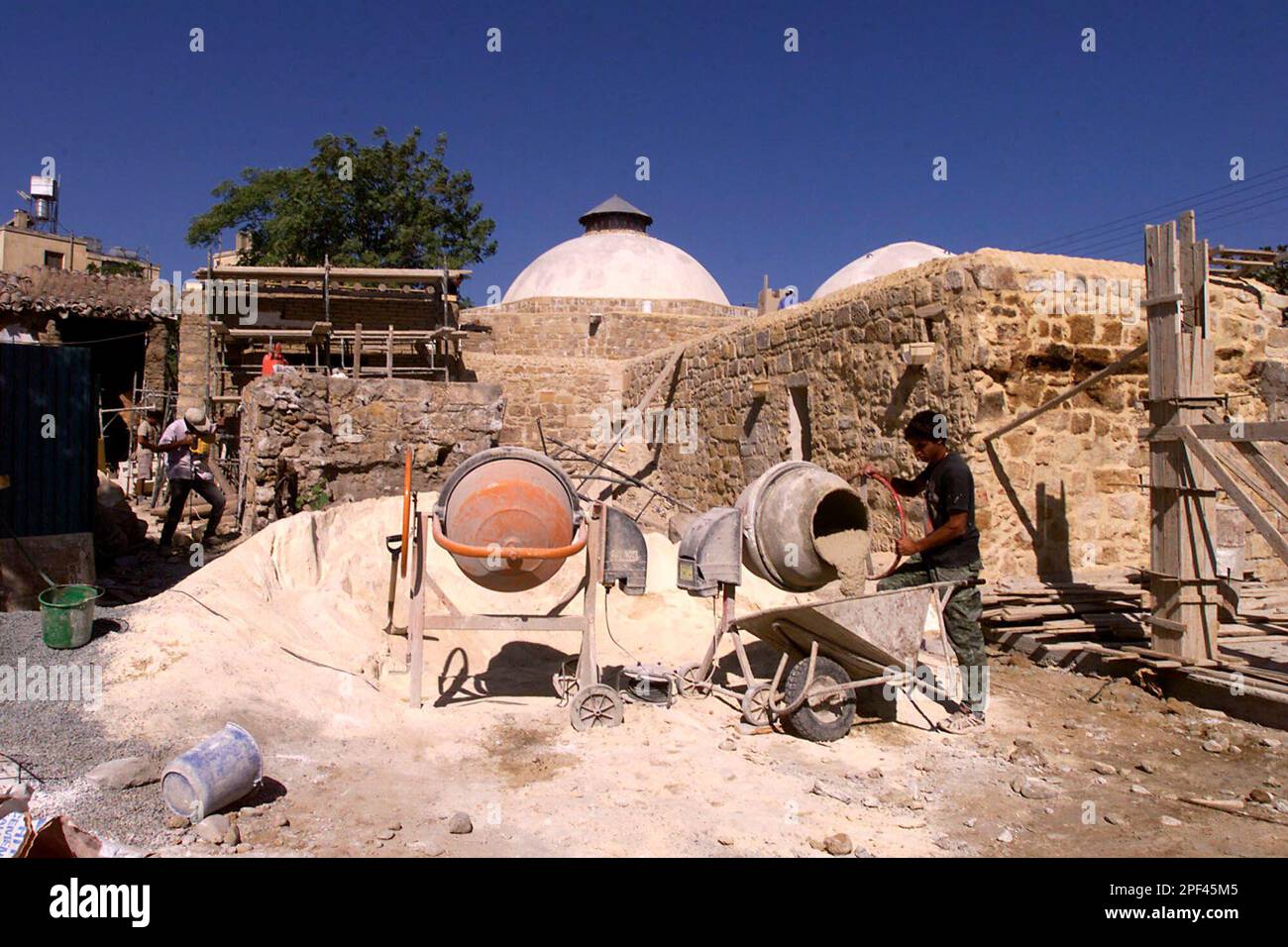 Builders work on the restoration of the Turkish baths in the Greek ...