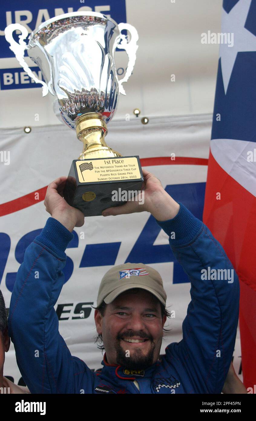Puerto Rico's Wally Castro holds up Trans-Am Series Championship trophy ...