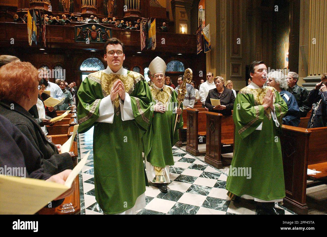 Cardinal Justin Rigali, center, the newly installed Archbishop of ...
