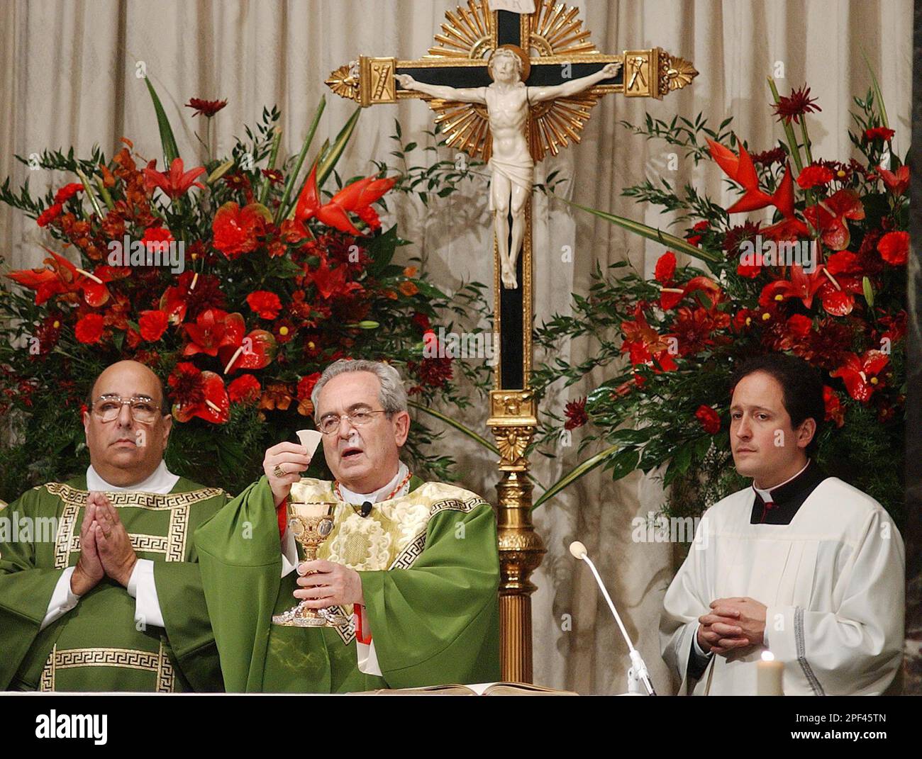 Cardinal Justin Rigali, center, the newly installed Archbishop of ...