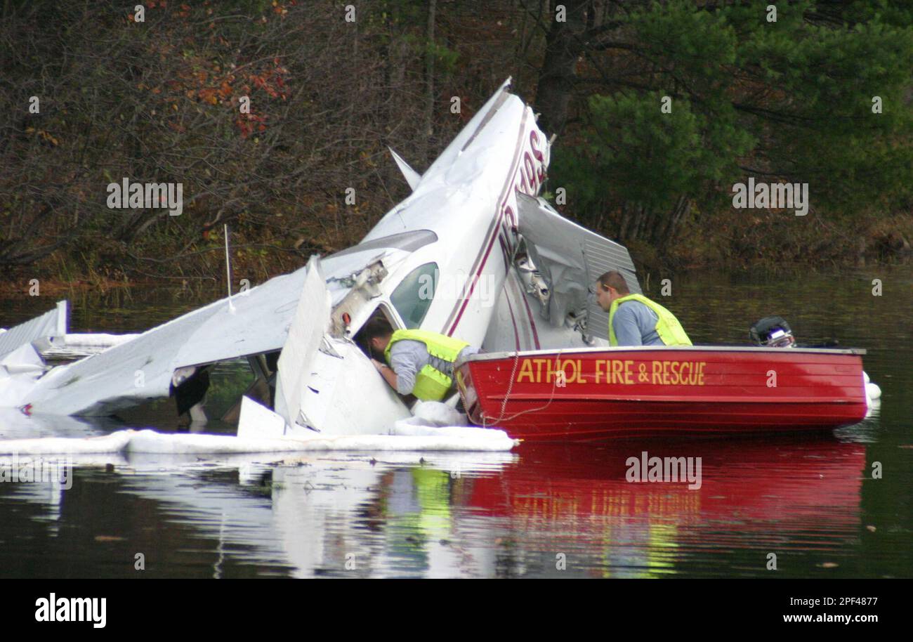 Members of the Athol, Mass., fire and rescue team look inside the ...