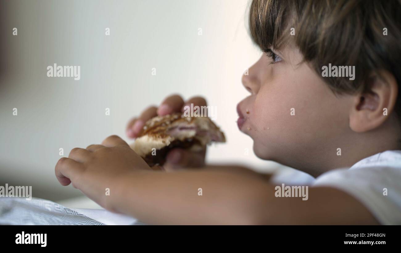 Little boy taking a big bite of bread. Child wide open mouth eating ...