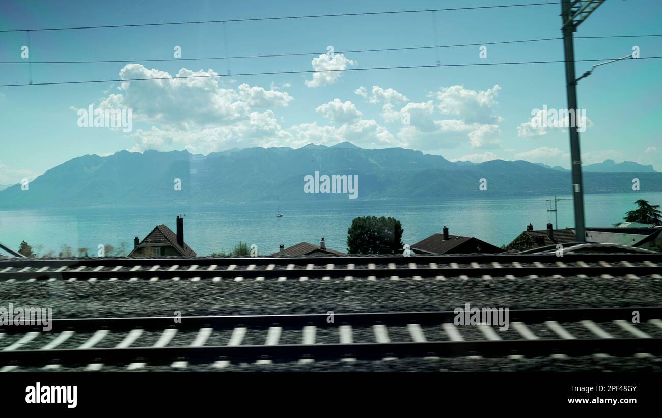Moving train landscape of lake with mountains in background. Beautiful ...