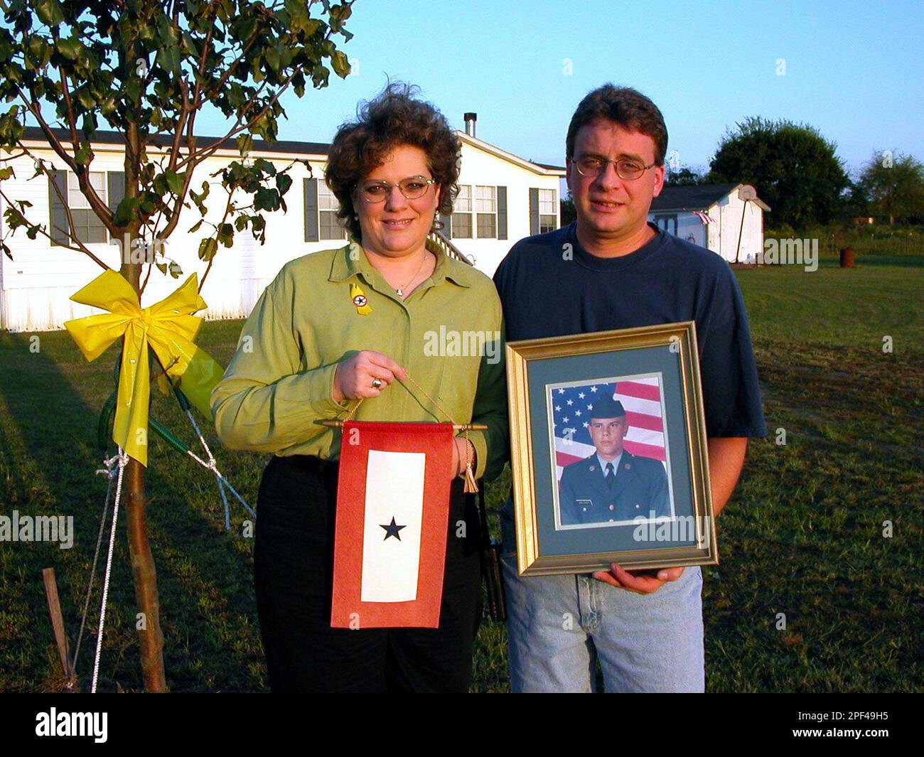 Tamera and Bill Lank, of Orangeburg, S.C., hold a picture of their son ...