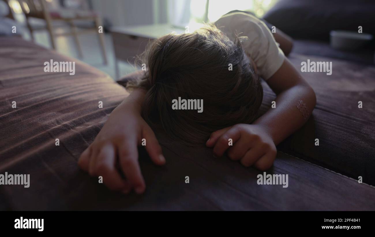 Sleeping child lying on couch napping. Kid in deep slumber asleep during afternoon nap. Cute ...