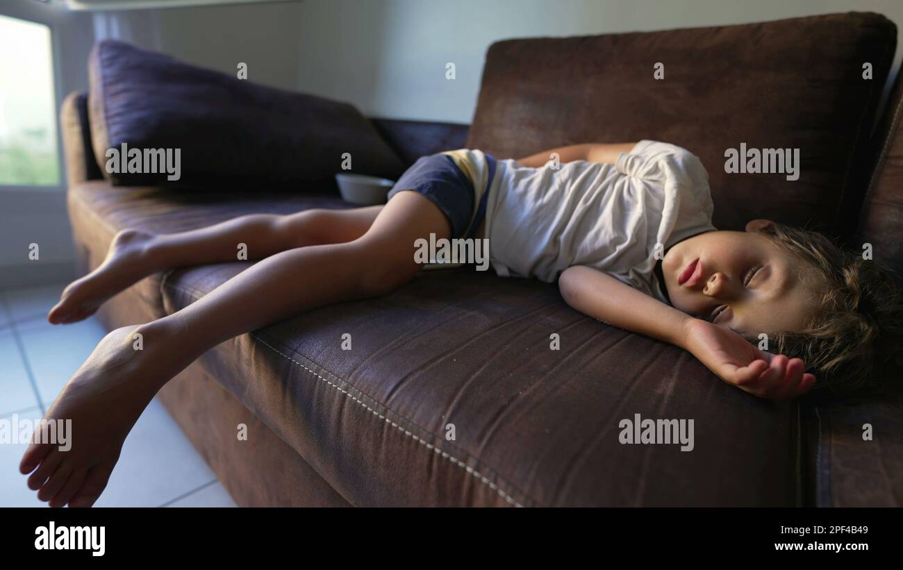 Sleeping child lying on couch napping. Kid in deep slumber asleep ...