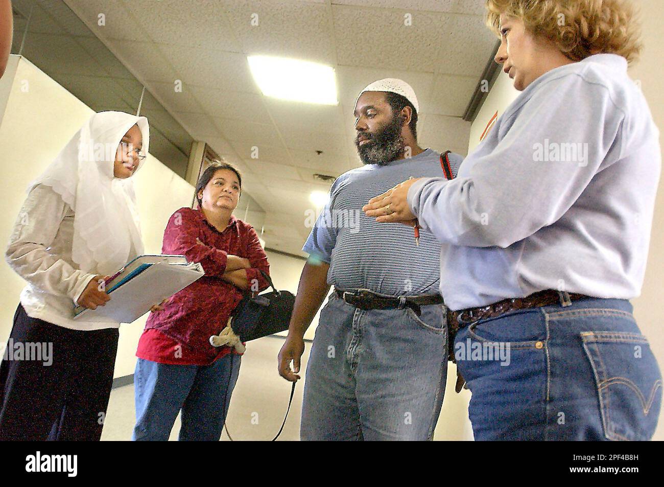 Nashala Hearn, left, and her parents, Rose and Eyvine Hearn, talk to ...