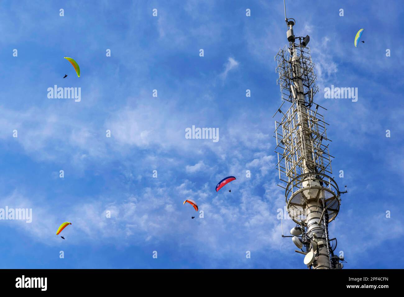 Paragliders flying over Mount Mercury with transmitter mast in Baden ...