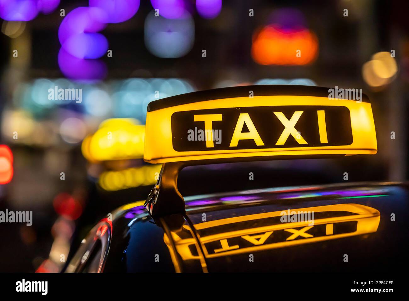 Taxi stand with taxi in the city centre at night, symbol photo ...