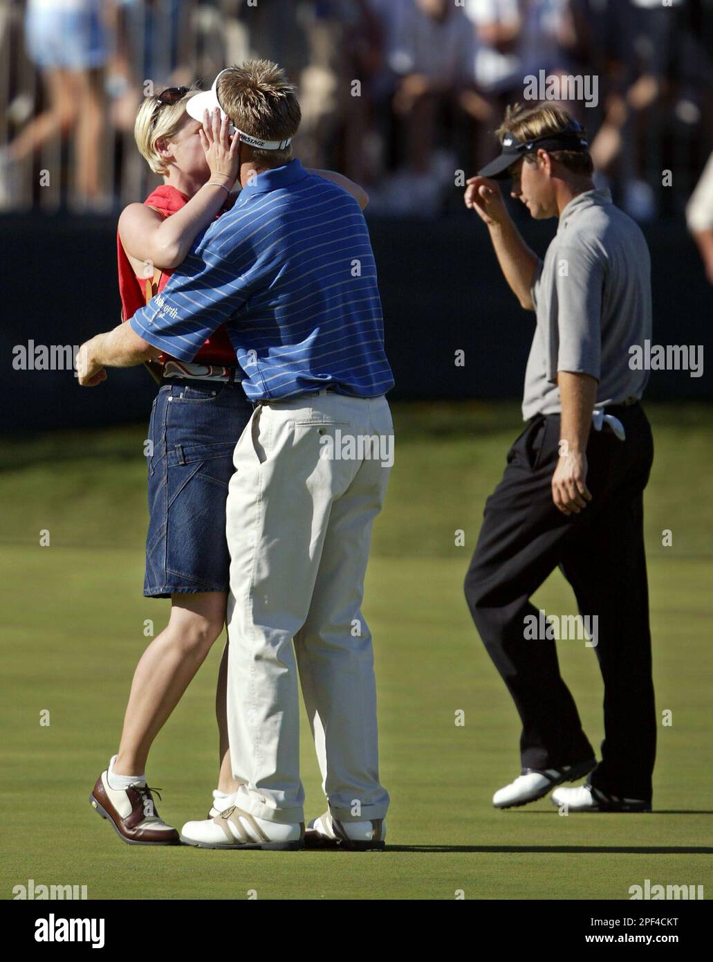 Stuart Appleby of Australia kisses his wife, Ashley, as Scott McCarron ...