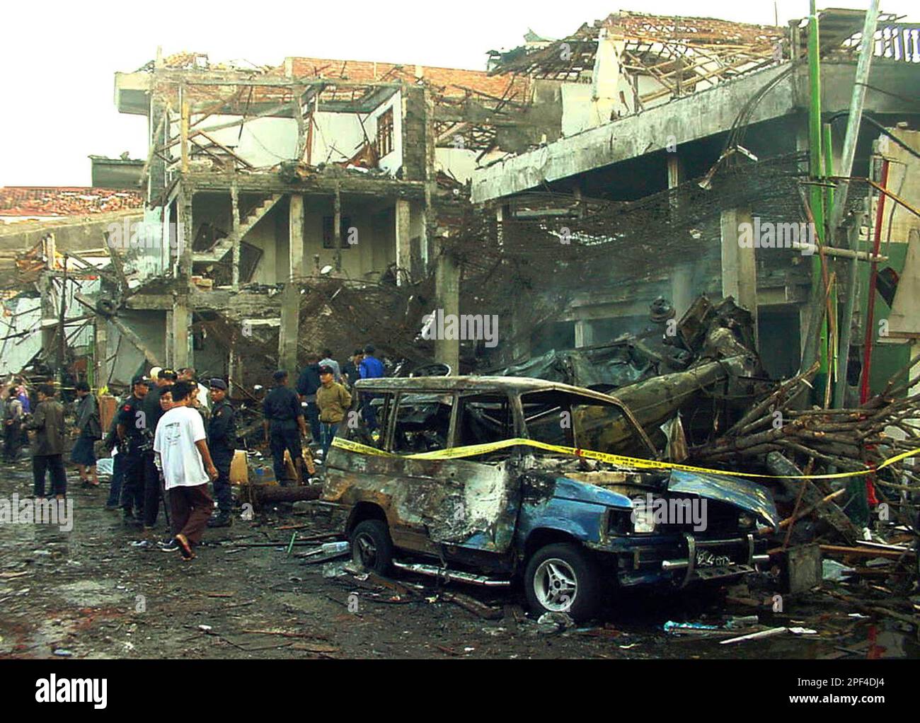 Police officers inspect the ruins of a nightclub destroyed by an ...