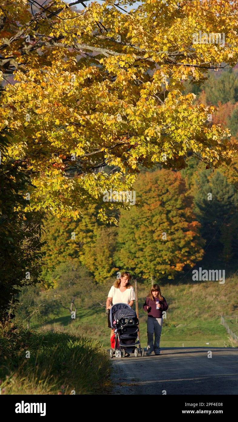 Marlene Betit pushes a carriage with her daughter, Mary Katherine, as ...