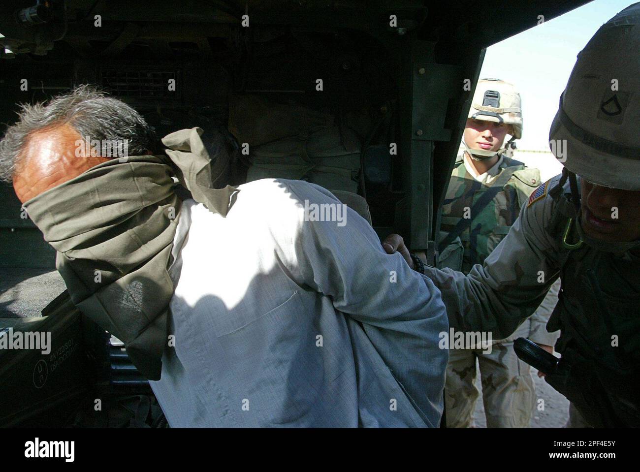 Soldiers from the U.S. Army's 720th Military Police Battalion load a ...