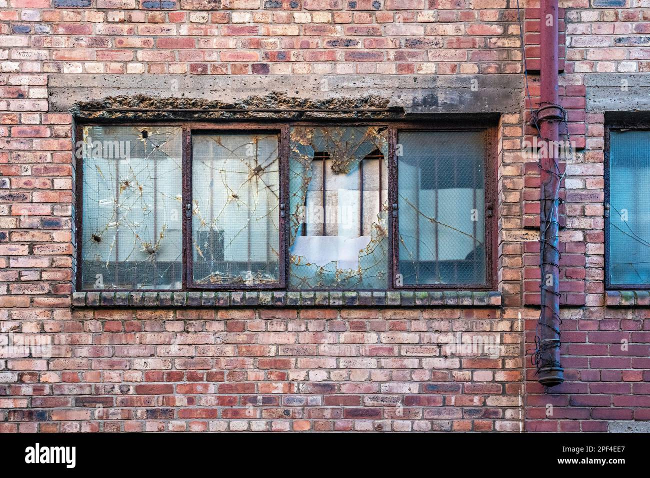 Damaged windows in Liverpool Docklands warehouse Stock Photo - Alamy