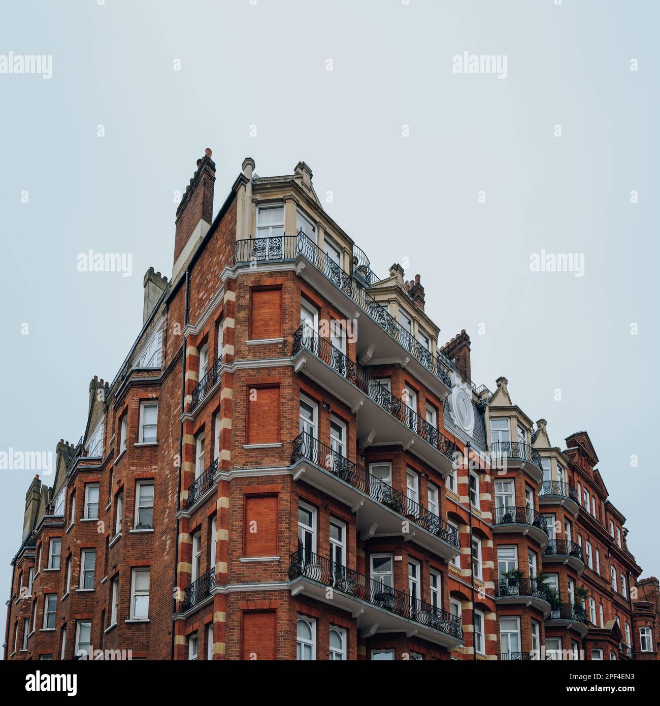 Traditional red brick apartment block with balconies in Kensington and ...