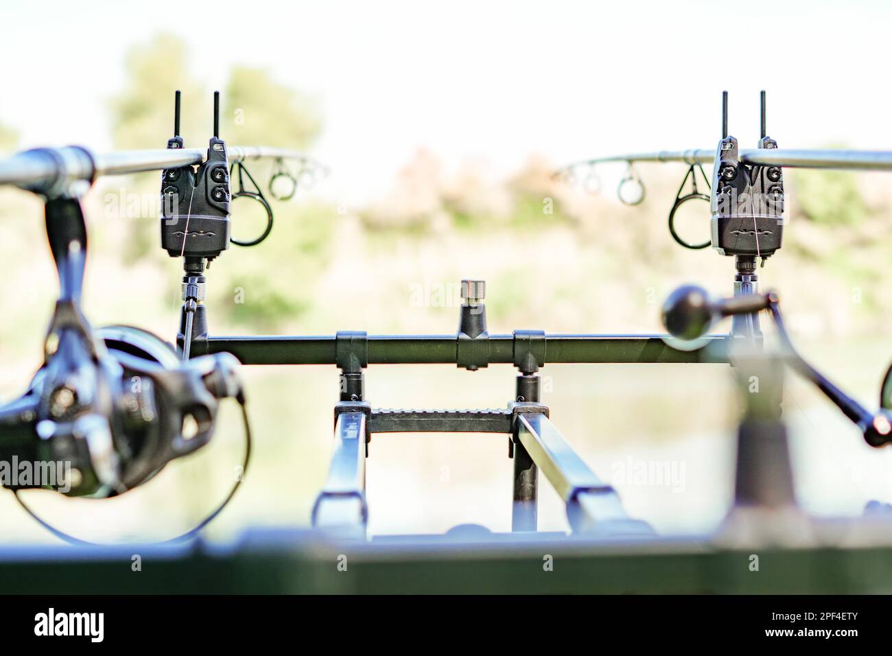 Close-up of a rod holder with alarms and two rods with their reels in ...