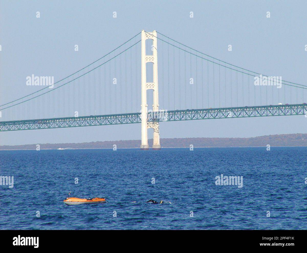 Ultra-endurance swimmer Jim Dreyer swims past the Mackinac Bridge with ...