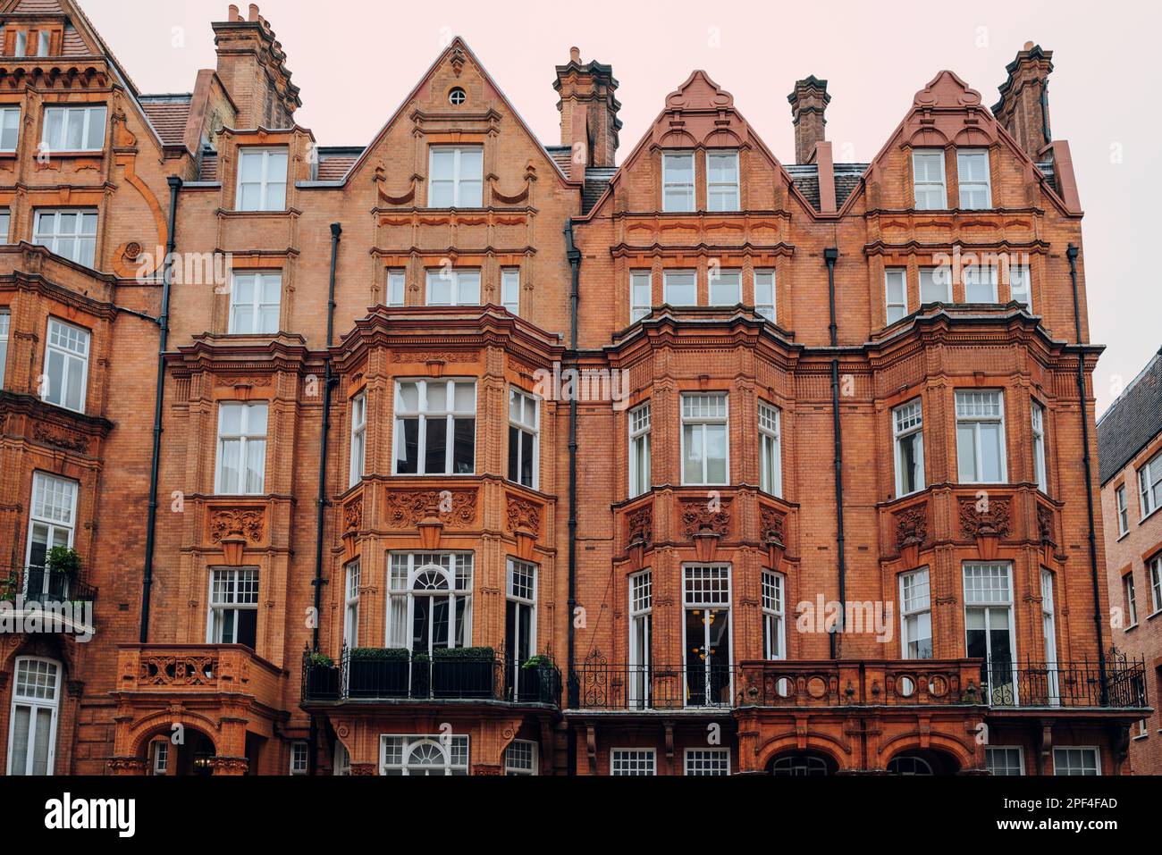 Traditional red brick houses with white window frames in Kensington and ...