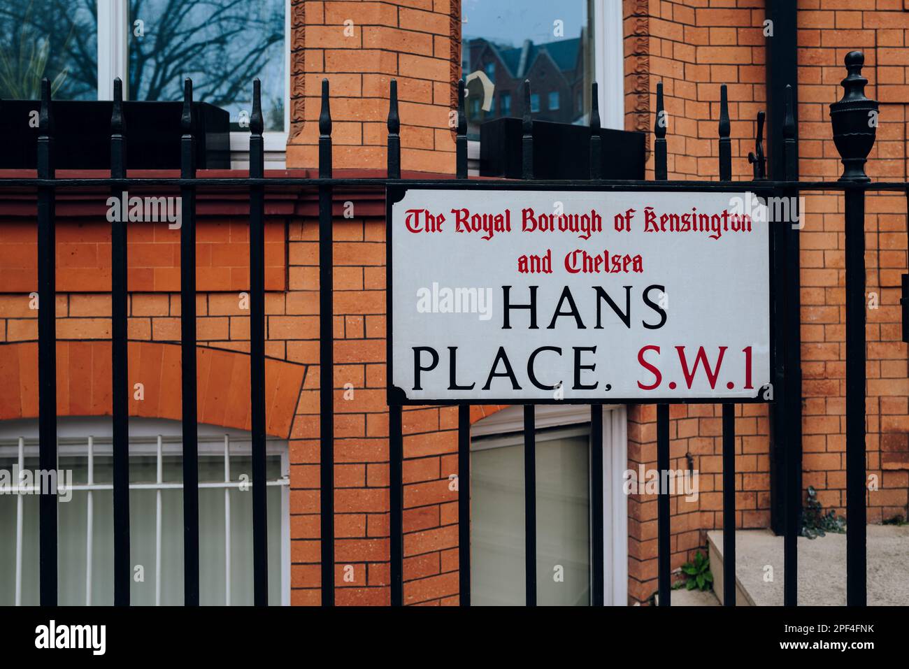 Hans Place street name sign on a black fence in The Royal Borough of ...