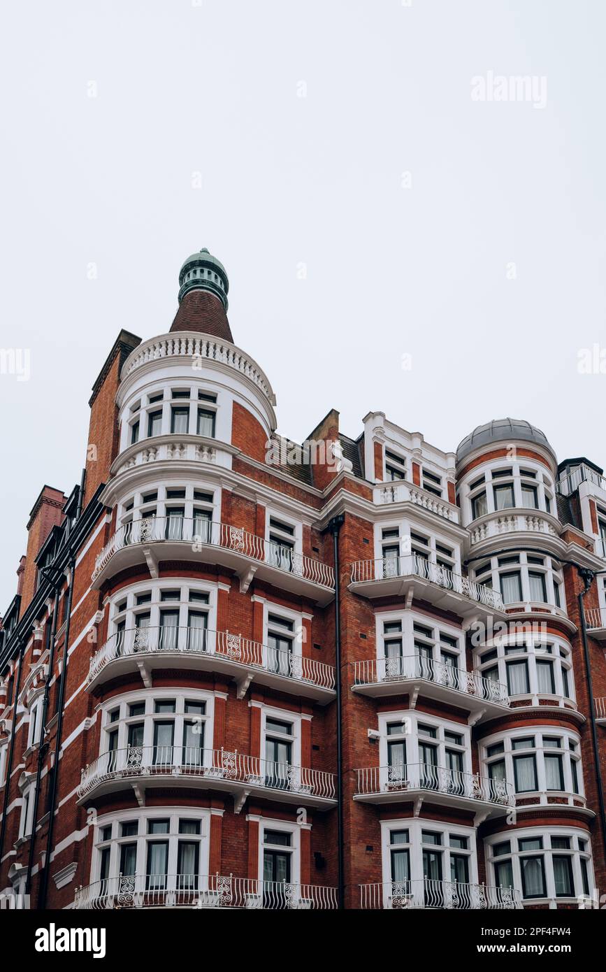 Traditional red brick apartment block with white window frames in ...