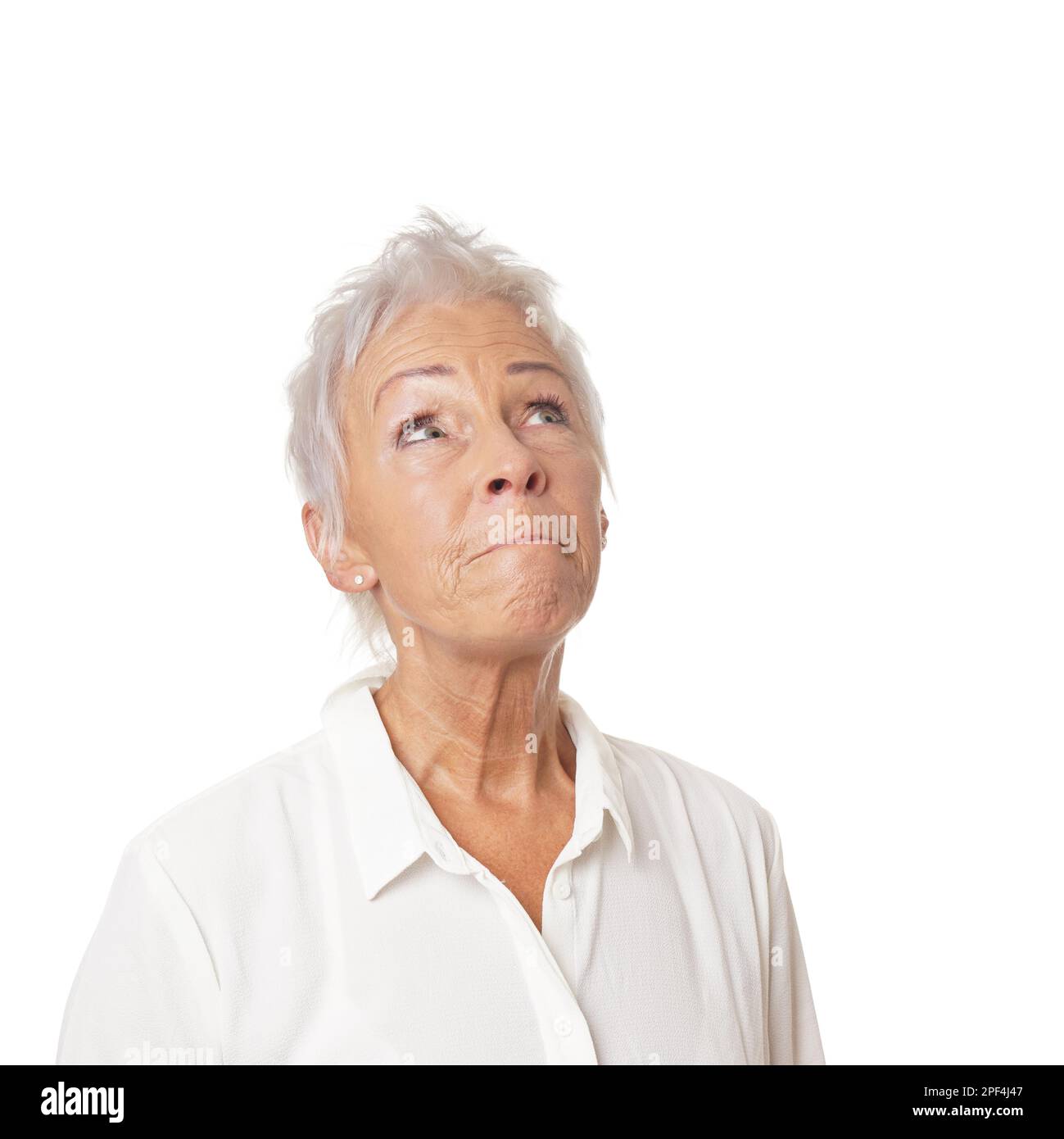 concerned senior woman looking up. isolated on white Stock Photo - Alamy
