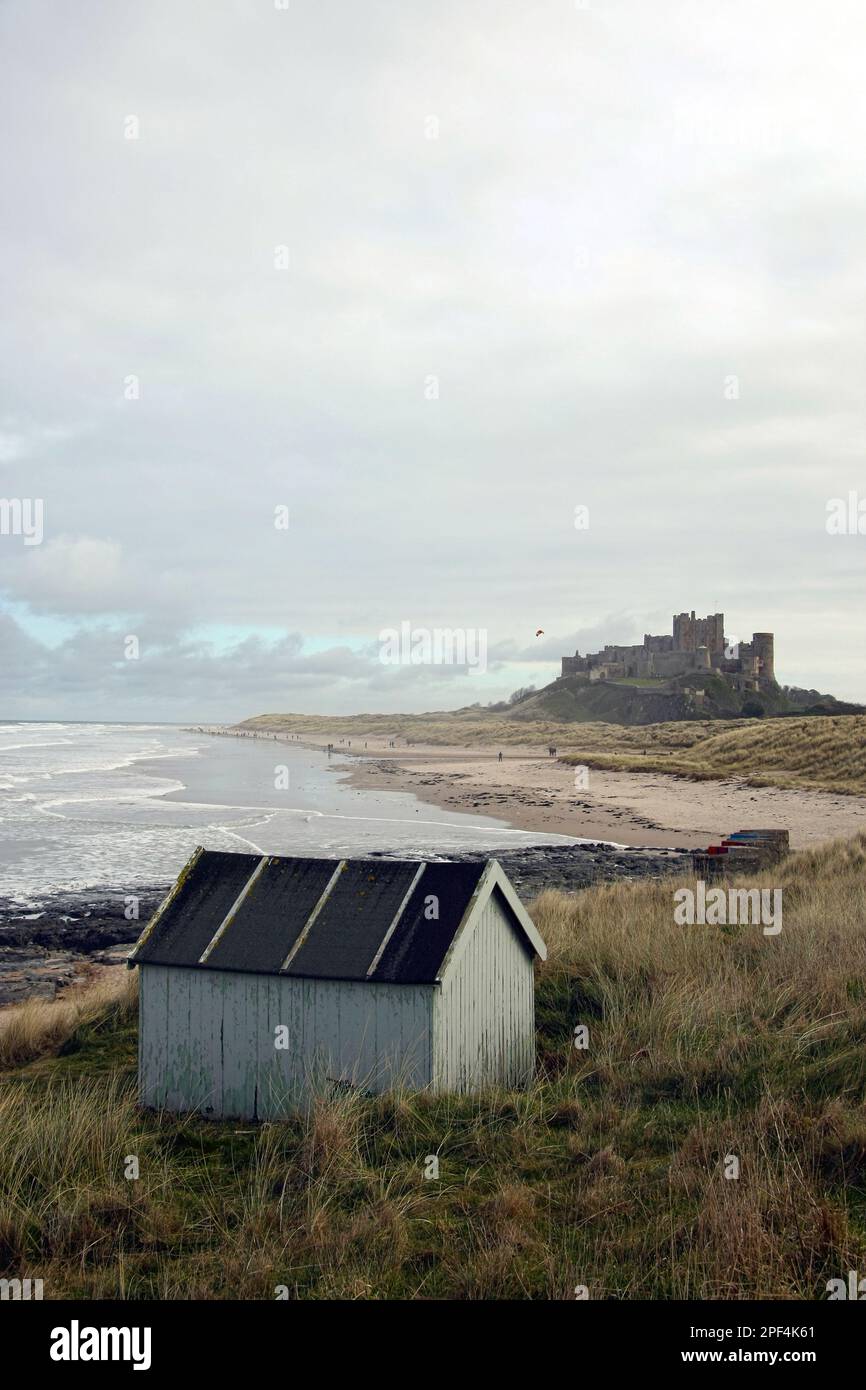Bamburgh Beach below the Castle, the imposing medieval castle and ...