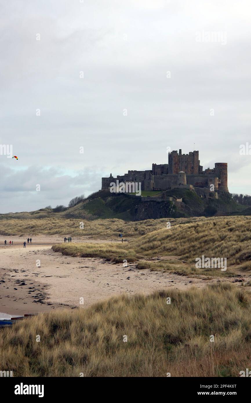 Bamburgh Beach below the Castle, the imposing medieval castle and ...