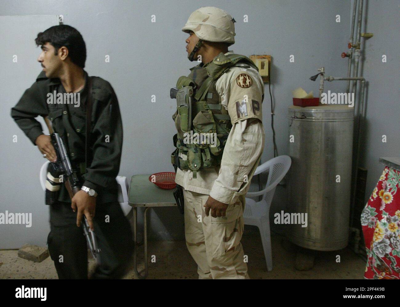 An Iraqi police officer and a member of the U.S. Army's 720th Military ...