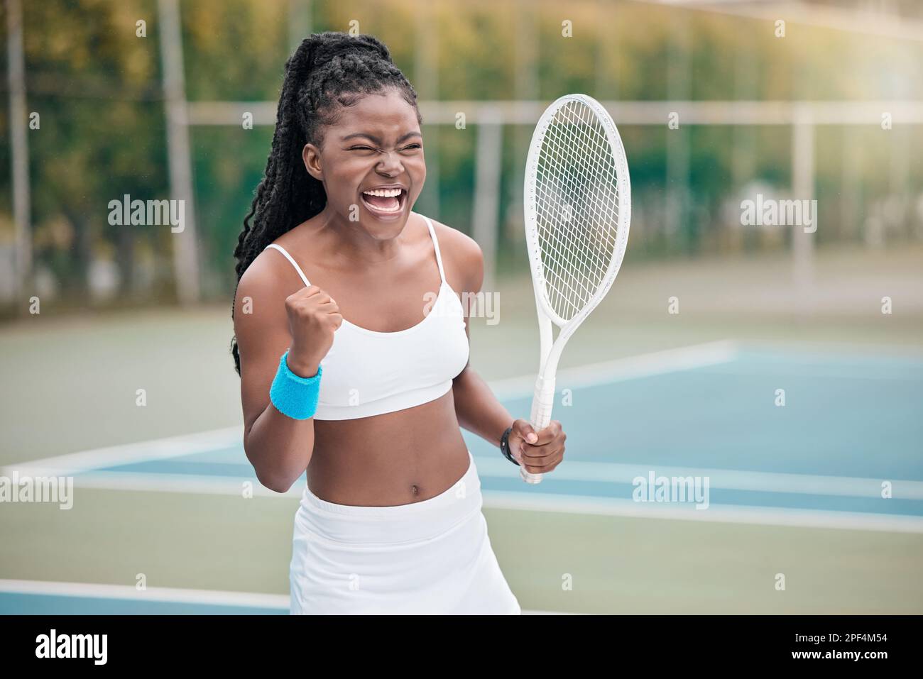 African american woman cheering after a tennis match. Young woman ...