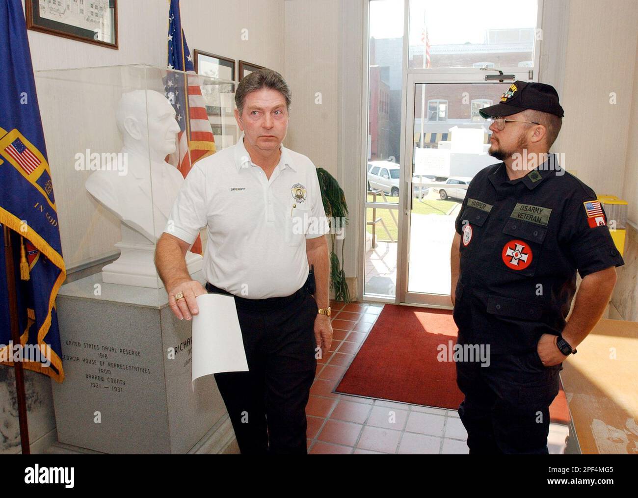 Barrow County Sheriff Joe Robinson, left, walks past a statue of ...
