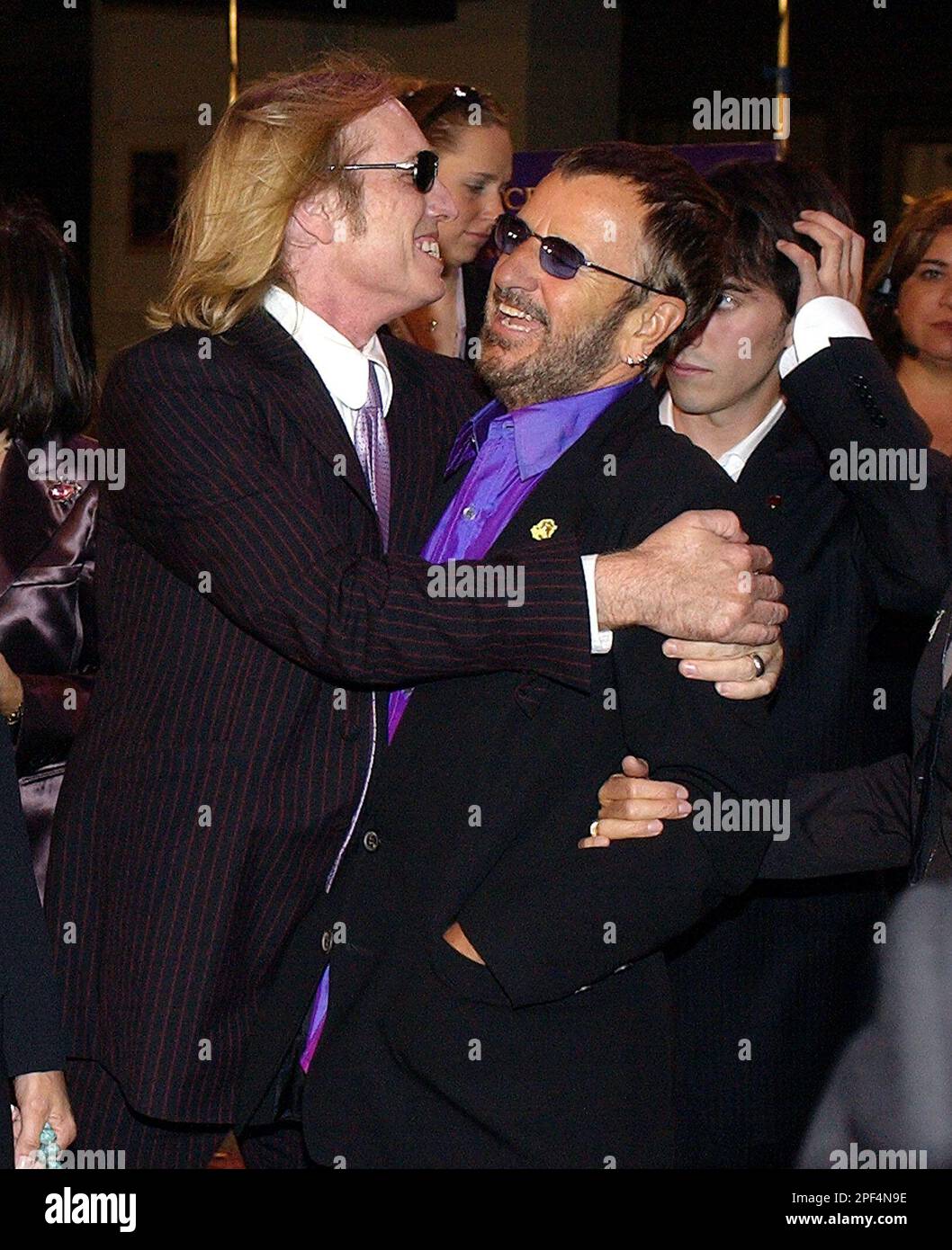 Tom Petty, left, hugs Ringo Starr as George Harrison's son Dhani, right ...