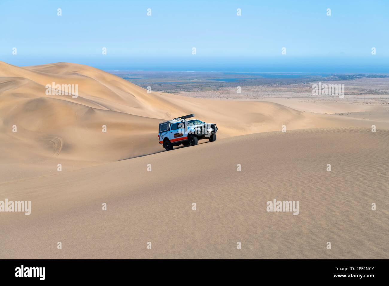 Off-road vehicle in sand dunes above the Orange River, also Oranjemund ...