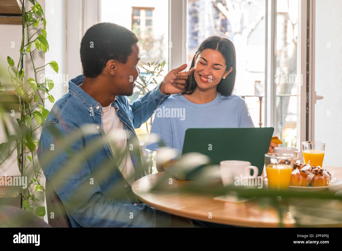 Multiethnic couple in love making online purchase with the computer ...