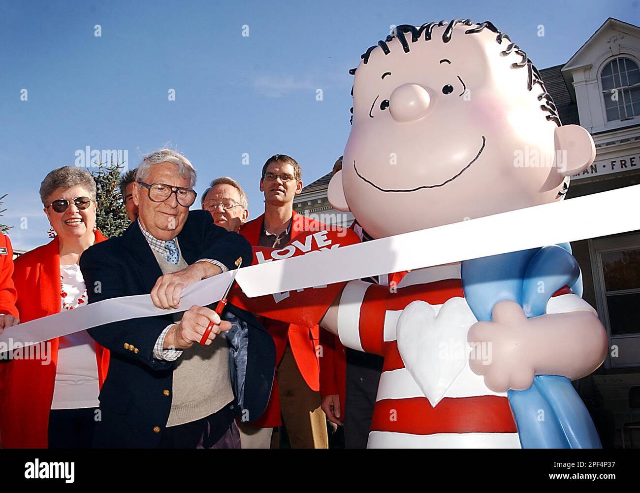 The real Linus artist Linus Maurer cuts a ribbon after unveiling a ...
