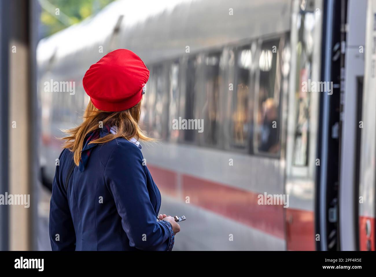 Train supervisor, Deutsche Bahn employee with red cap, Stuttgart main ...