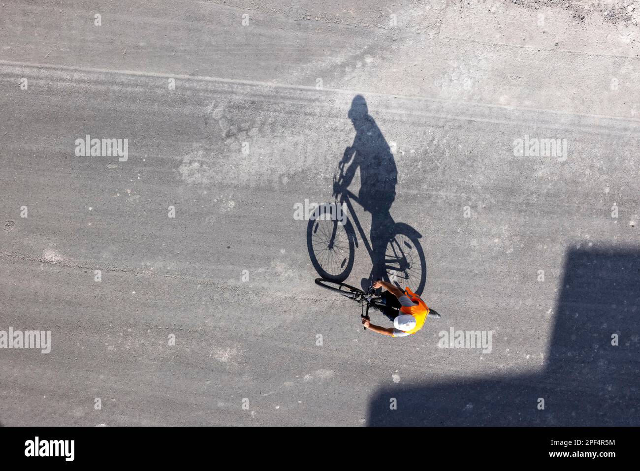 Construction worker with safety helmet driving on a road, he casts a ...