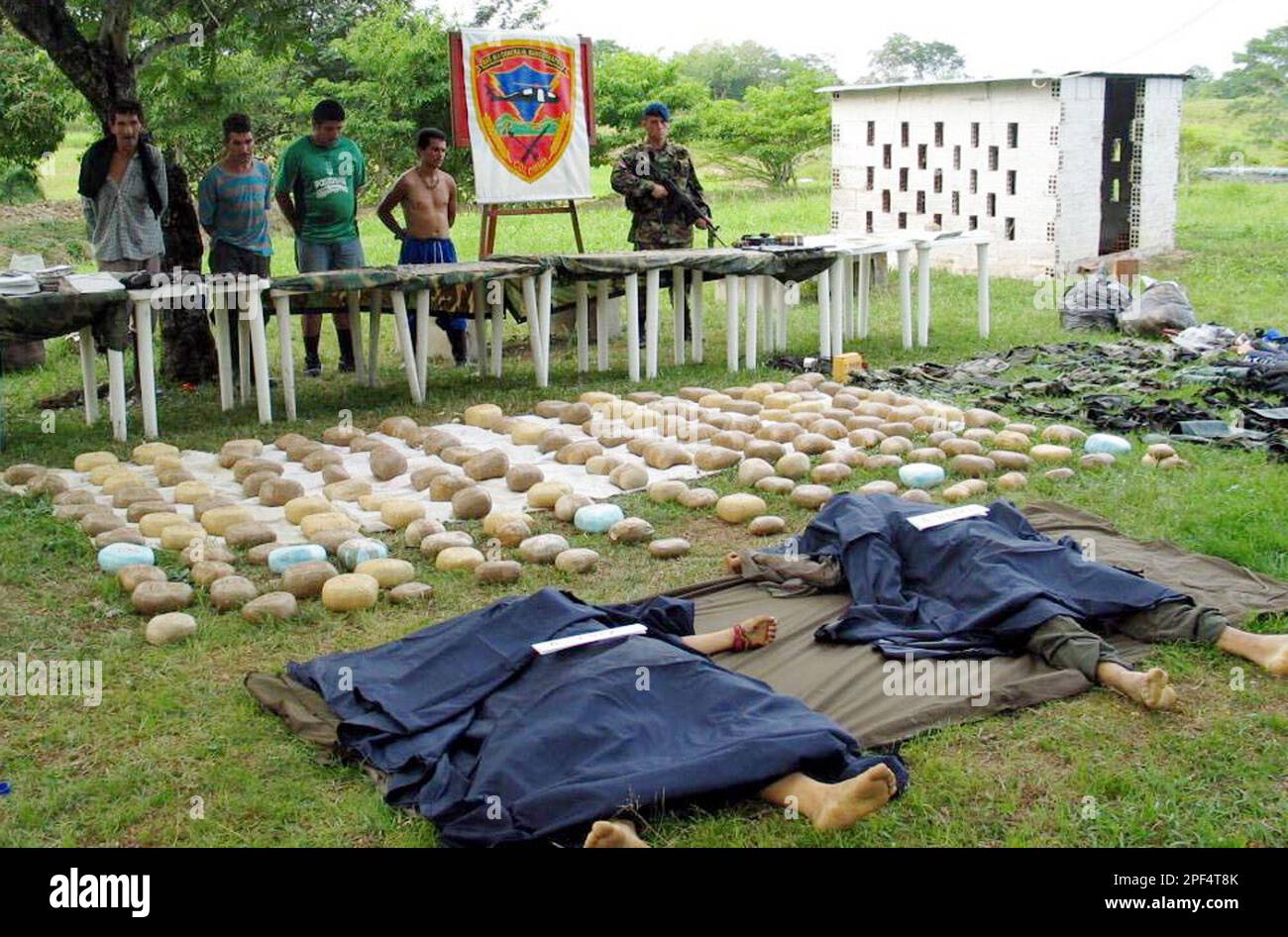 Soldiers shows two bodies of alleged members of Revolutionary Army ...