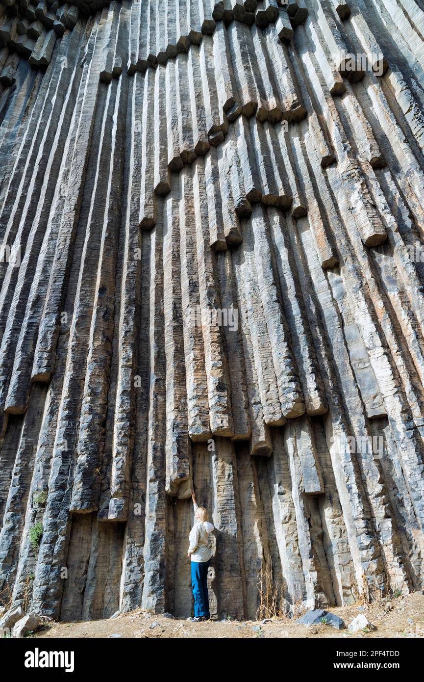 Symphony of Stones, woman under the basalt column formation along the ...