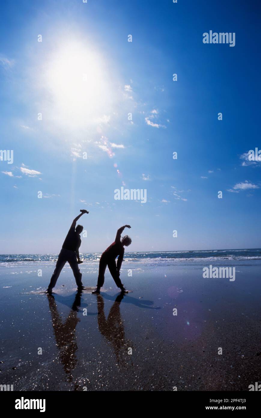 Senior couple working out doing calisthenics on a summer day at the ...