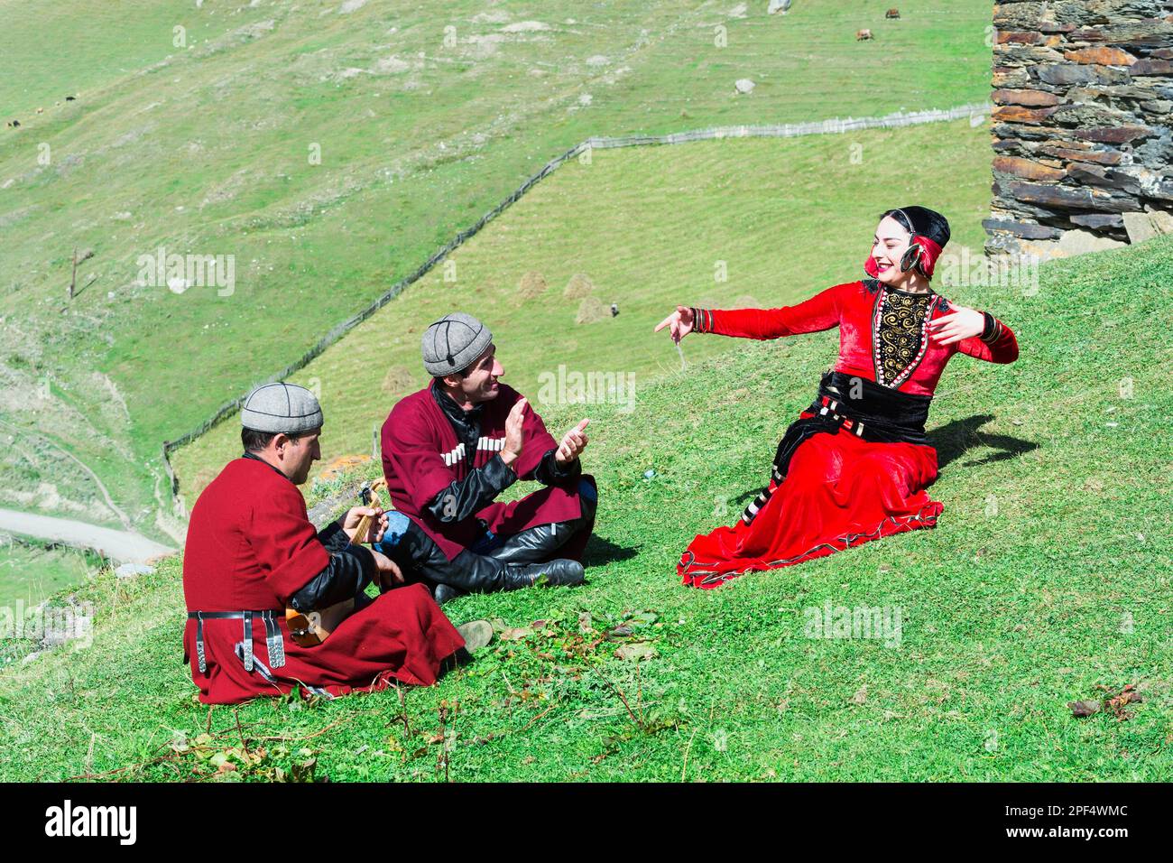 Georgian people from a folkloric group playing panduri and dancing in ...