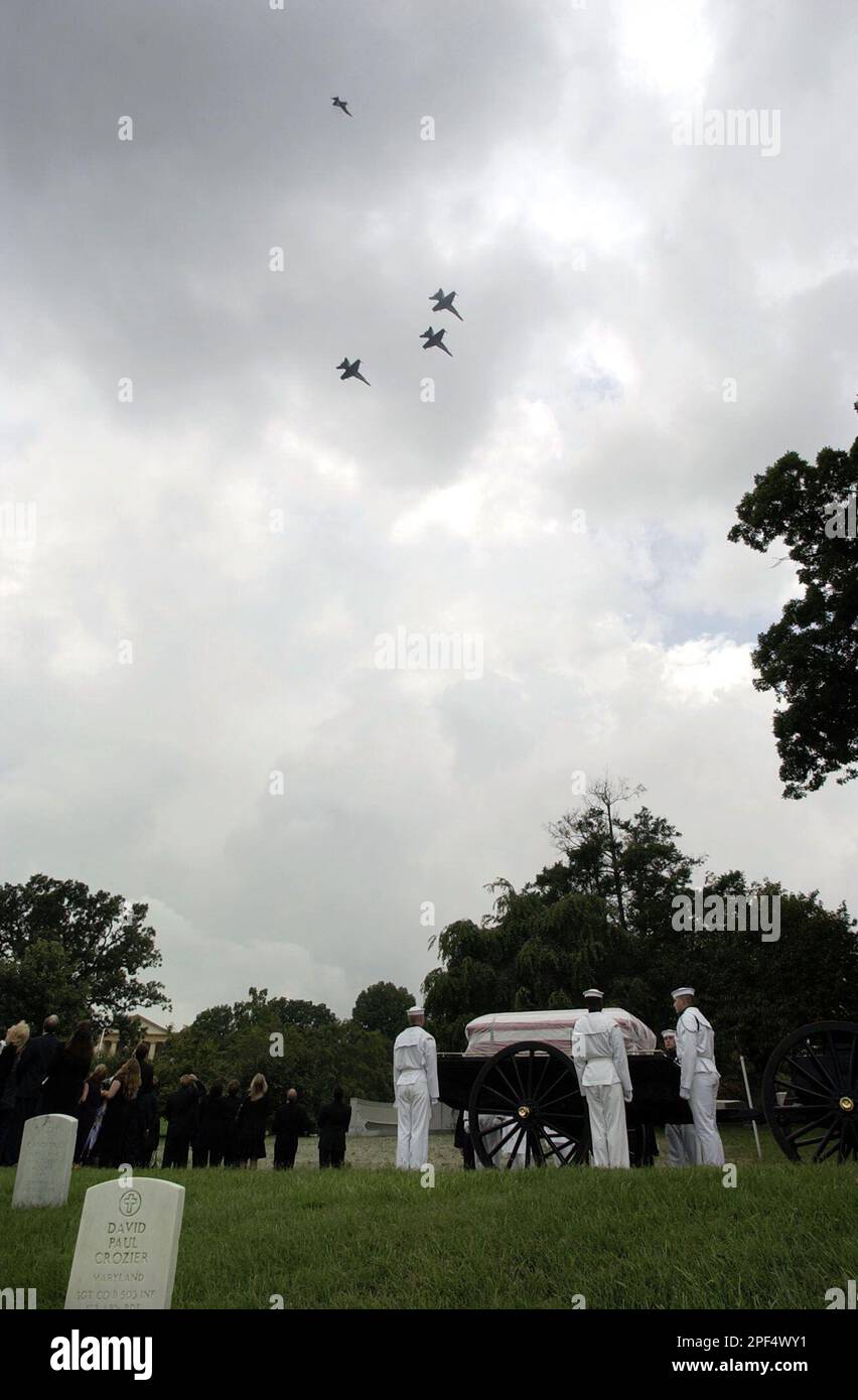 Military jets perform a missing man fly-by over the caisson carrying ...