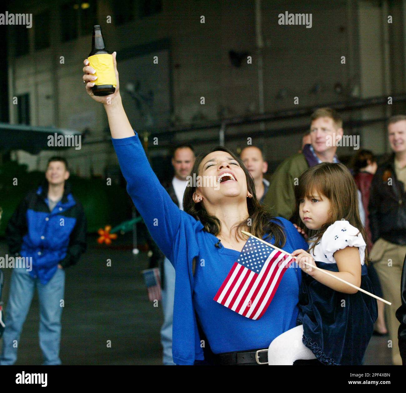 Cyndi Whelpley, holding her daughter, Brooke, lets out a yell that she ...