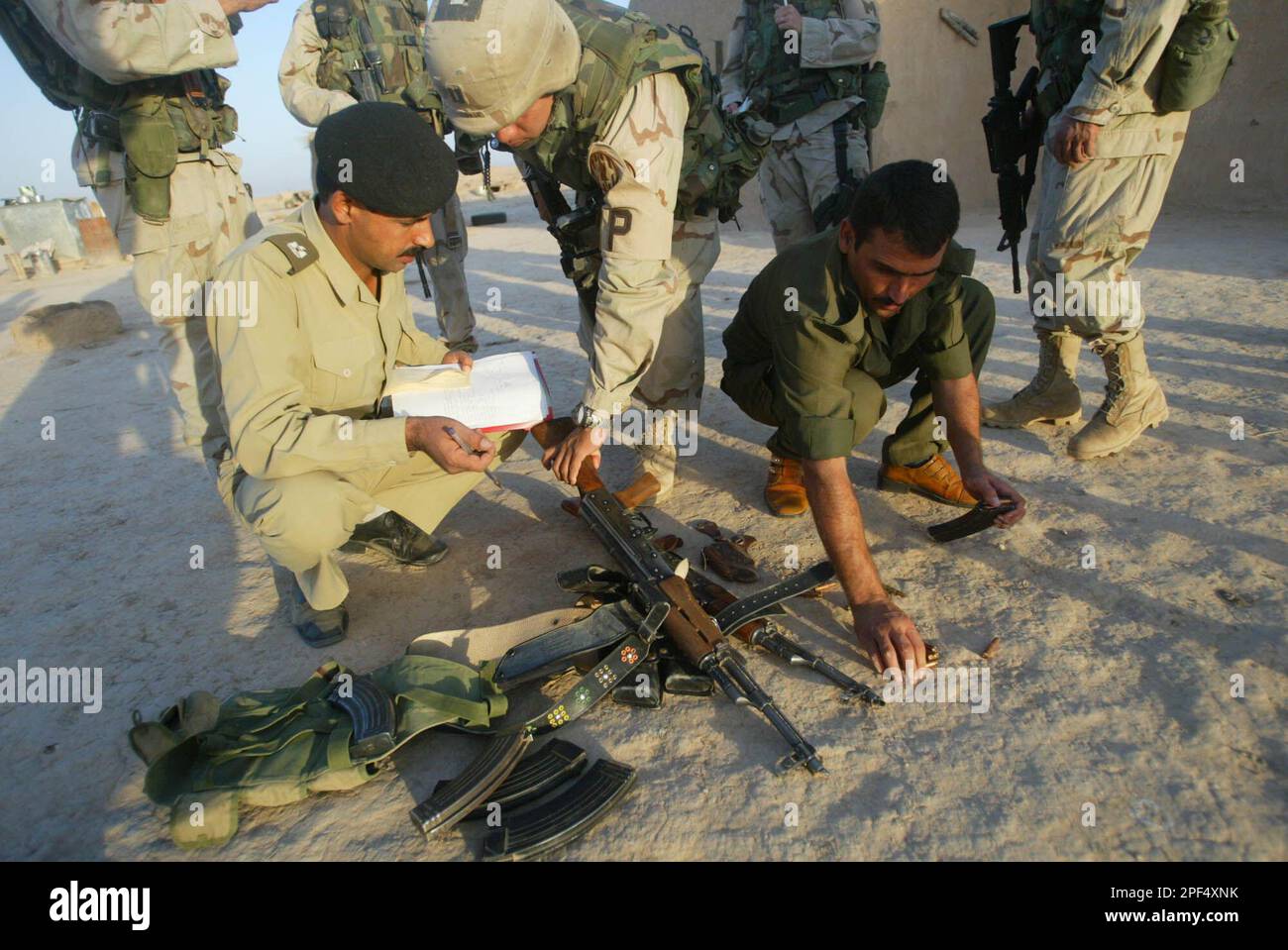 A US soldier center, from the 720 Military Police battalion places ...