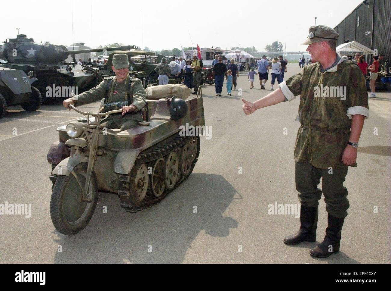 Larry Mayo, left, of Chicago, slows his Kettenkrad, a World War II-era ...